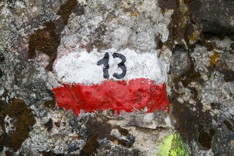 High Angle Shot of a NO 13 Sign on White and Red Lines Painted the ...