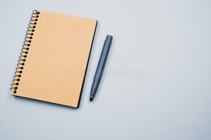High Angle Shot of a Notebook and a Marker on a Blue Surface Stock ...