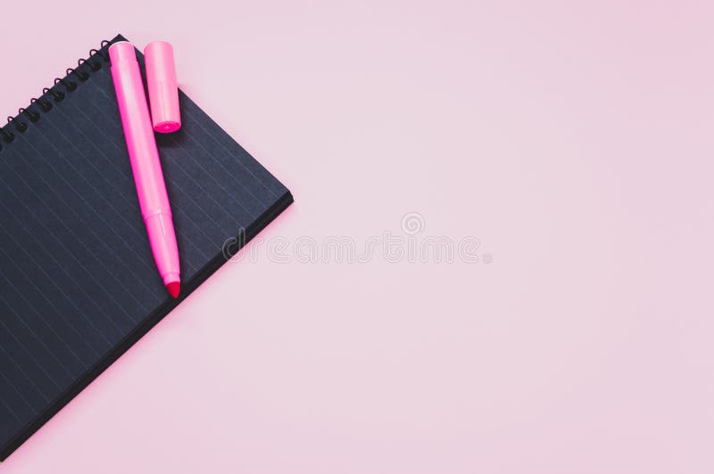 High Angle Shot of a Notebook and a Pink Marker on a Pink Surface Stock ...