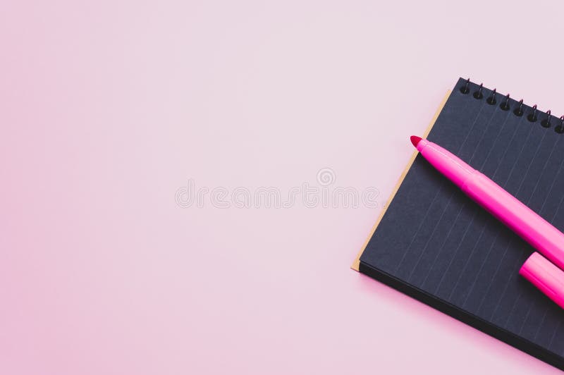 High Angle Shot of a Notebook and a Pink Marker on a Pink Surface Stock ...