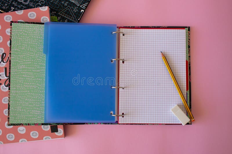 High Angle Shot of a Pencil and an Eraser on the Journal on a Pink ...