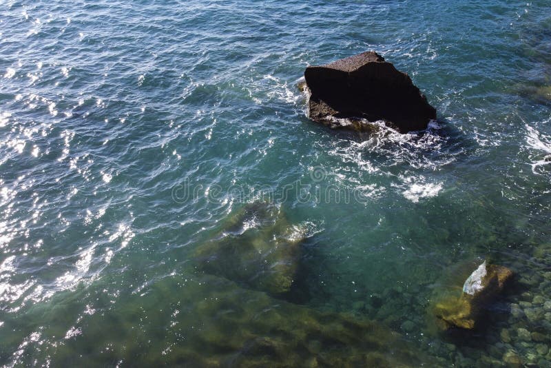 High Angle Shot of a Perfect Clean Water with Some Sharp Rocks Stock ...