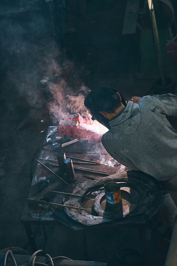High Angle Shot of a Person Welding Different Metal Elements Stock ...