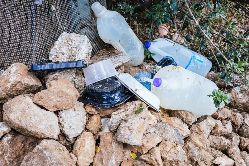 High Angle Shot of Plastic Bottles of Water and Garbage Thrown on the ...
