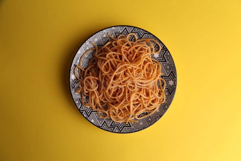 High Angle Shot of a Plate of Delicious Spaghetti Isolated on a Yellow ...