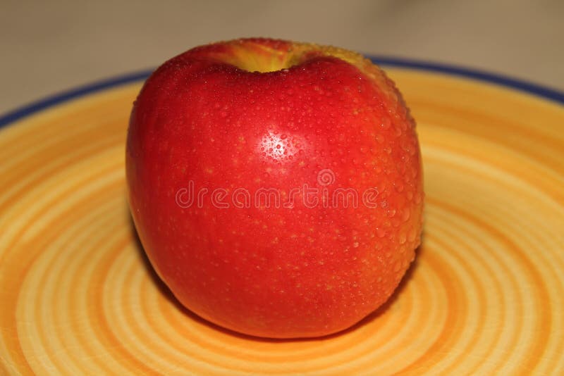 High Angle Shot of a Red Apple in the Middle of a Plate Stock Photo ...