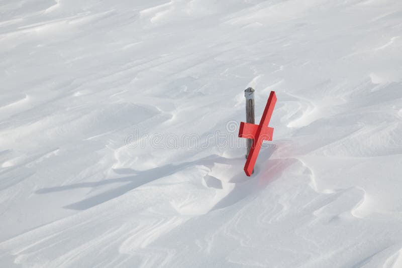 High Angle Shot of a Red Cross Sign in Snowy Slope Under the Sunlight ...