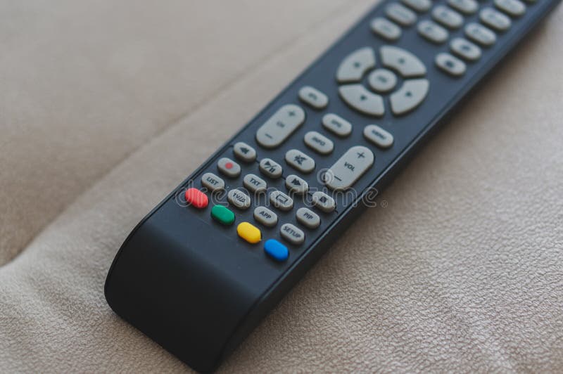 High Angle Shot of a Remote Control on a Cream Sofa Stock Photo - Image ...