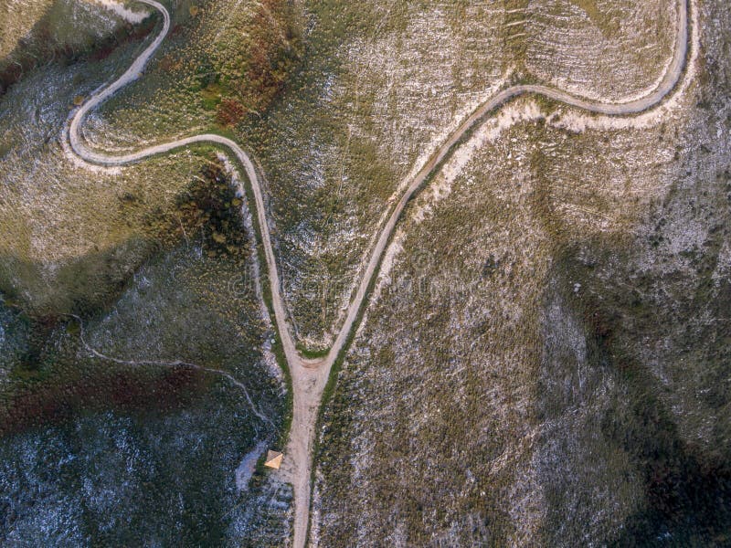 Aerial View of Winding Paths Across a Snow-dusted Hillside. a Small ...