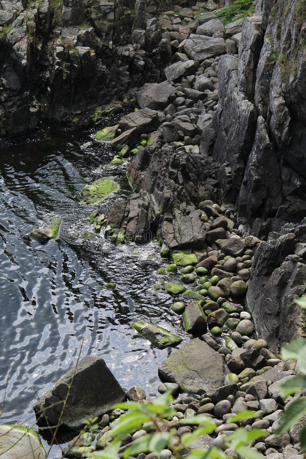 Rock covered riverbank stock image. Image of rock, environment - 150472051