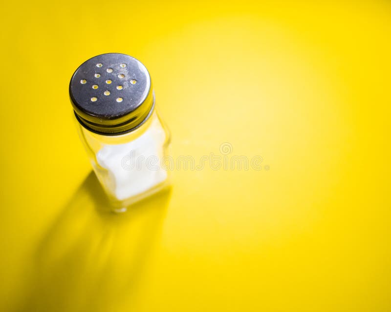 High Angle Shot of a Salt Shaker on a Yellow Surface Stock Photo ...