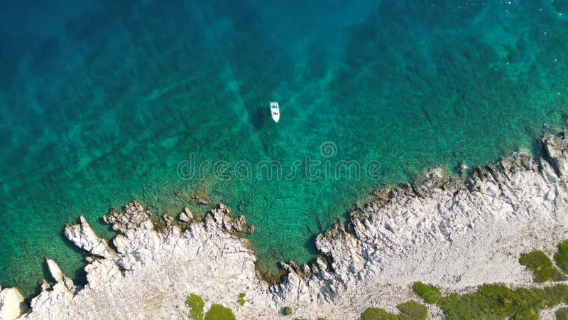 High Angle Shot of a Single Boat on the Water by the Beach. Stock Photo ...