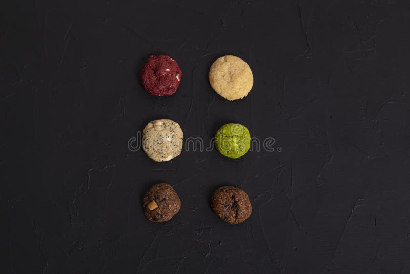 High Angle Shot of Six Different Cookies on a Black Rough Surface Stock ...