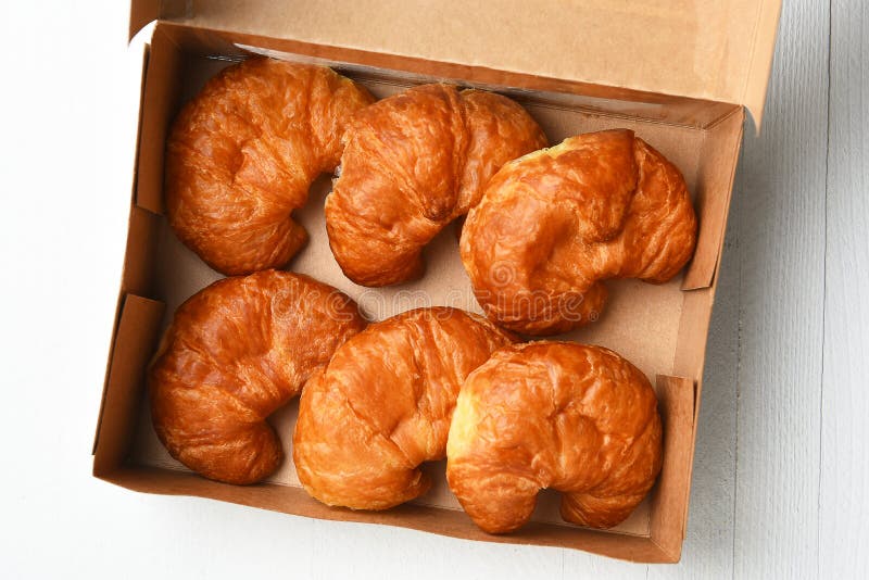 High Angle Shot of Six Fresh Baked Croissants in an Open Bakery Box ...