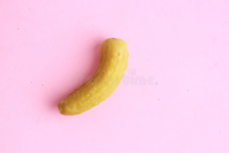 High Angle Shot of a Small Pickle Isolated on a Pink Surface Stock ...