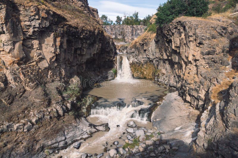 High Angle Shot of a Small Waterfall in the Rocky Cliffs in a Deserted ...