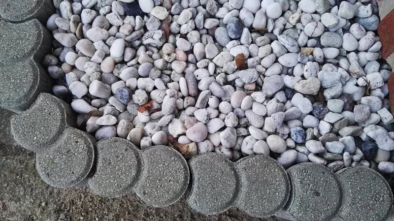 High Angle Shot of Small White Rocks Bunch Surrounded by Grey Tiles ...