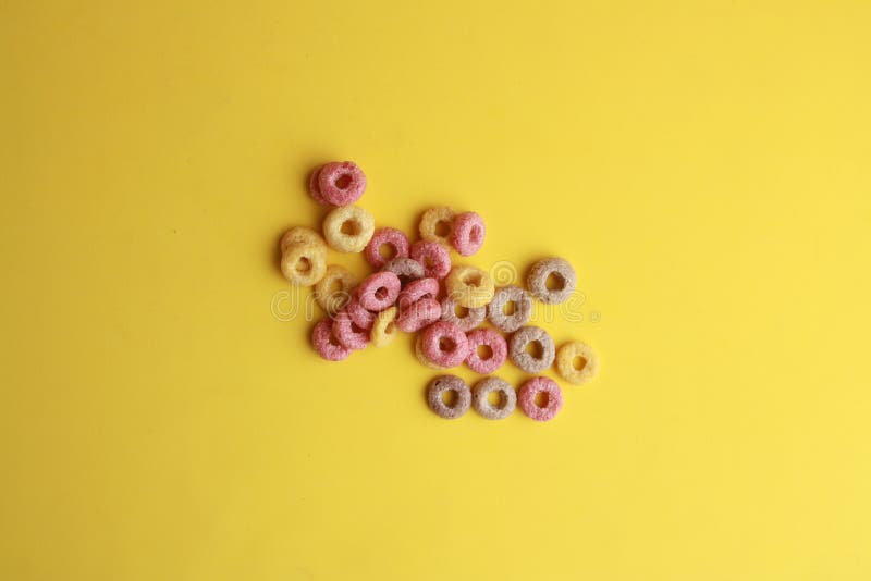 High Angle Shot of Some Colorful Fruit Loops Isolated on a Yellow ...