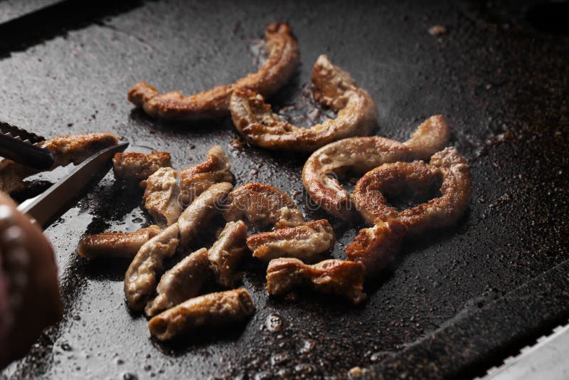 High Angle Shot of Some Pieces of Delicious Fried Meat on a Black Tray ...