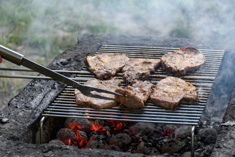 High Angle Shot of Steaks Cooking on a Flaming Grill Stock Photo ...