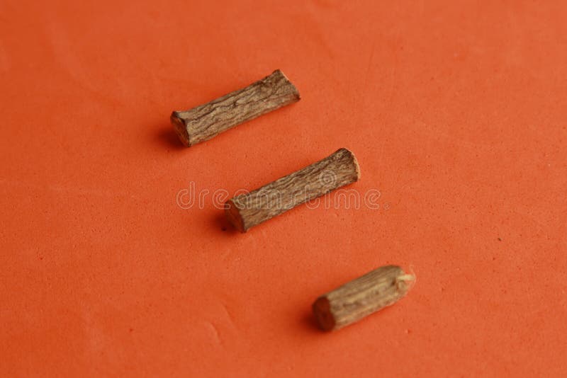 High Angle Shot of Three Sticks of Cinnamon Isolated on an Orange ...