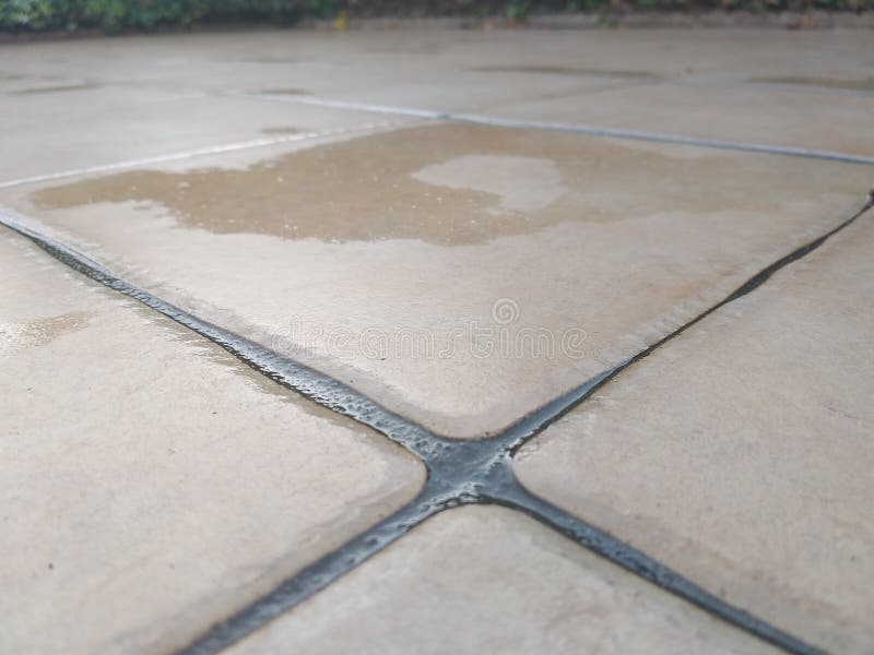 High Angle Shot of a Tiled Ground with a Wet Part on Some of it Stock ...