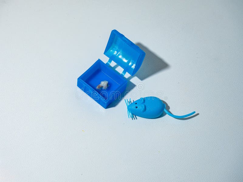 High Angle Shot of a Tooth in a Blue Box Next To a Blue Mouse Toy on a ...