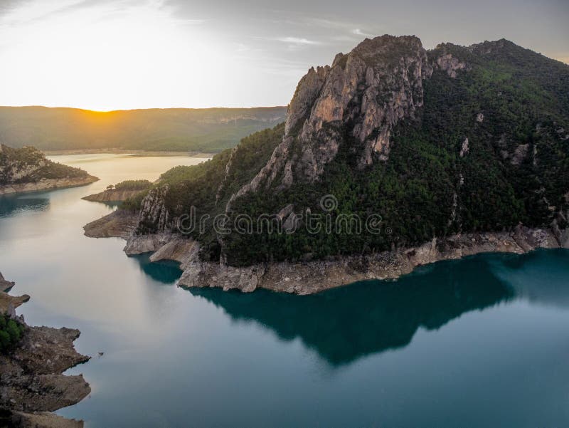High Angle Shot of the Tree-covered Hill by the Calm and Tranquil Lake ...