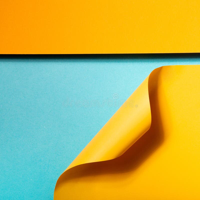 High Angle Shot of a Yellow Half-rolled Paper on a Blue Background ...