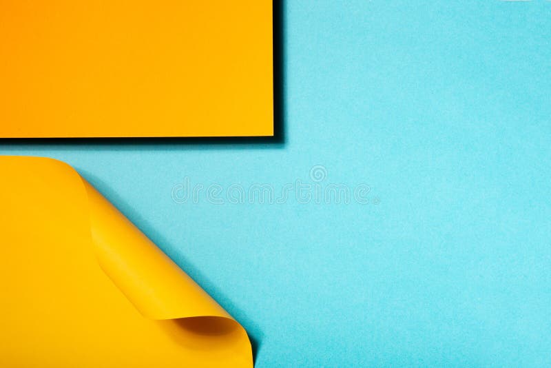 High Angle Shot of a Yellow Half-rolled Paper on a Blue Background ...
