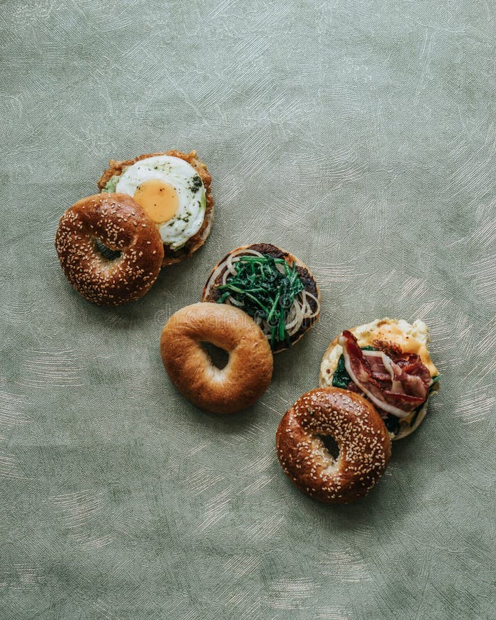 A High Angle of Three Breakfast Sandwiches on a Plate with Bagels, Eggs ...