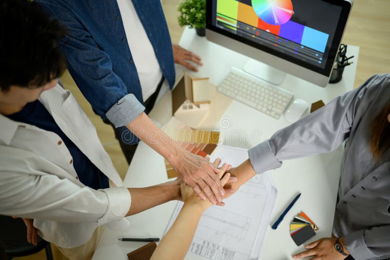 High Angle View of Architects or Interior Designers Stacking Hands Over ...