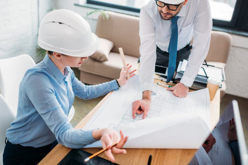 High Angle View of Architects Working with Building Plan Stock Photo ...