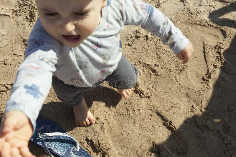 High Angle View of a Baby Boy Having His Firts Steps in the Sand Stock ...