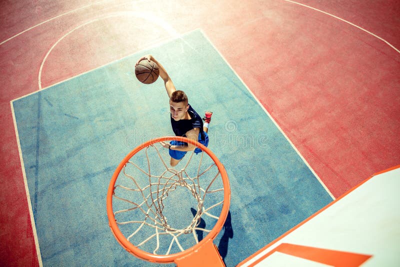 High Angle View of Basketball Player Dunking Basketball in Hoop Stock ...