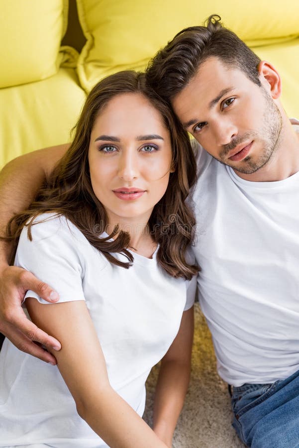 High Angle View of Beautiful Young Couple Embracing and Looking at ... High Angle View of Beautiful Young Couple Embracing and Looking at ...