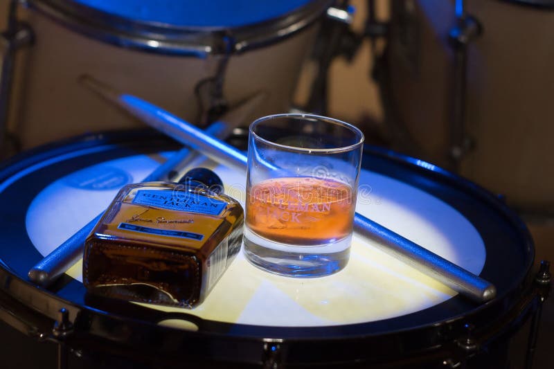 High-angle View of a Bottle of Gentleman Jack and a Glass of Whiskey on ...