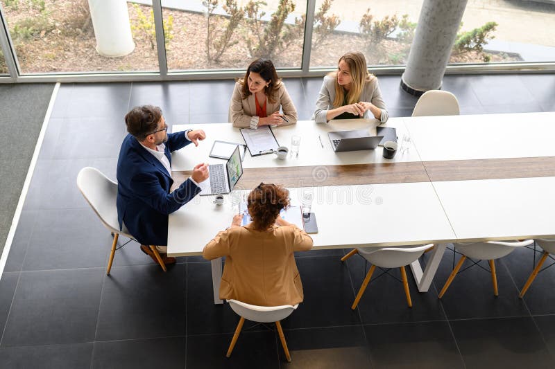 High Angle View of Business Professionals with Technologies and ...