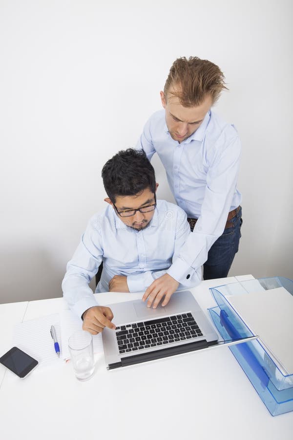 High Angle View of Businessmen Using Laptop in Office Stock Image ...