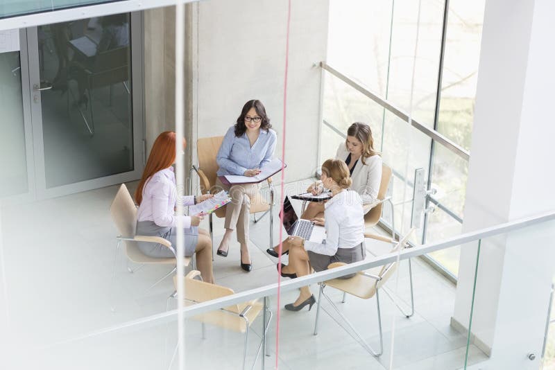 High Angle View of Businesswomen Discussing in Office Stock Image ...