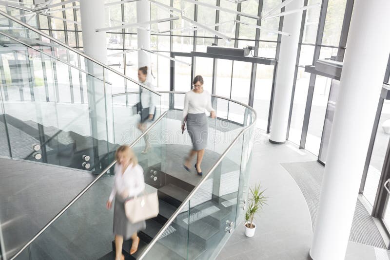 High Angle View of Businesswomen on Staircase at New Office Stock Photo ...