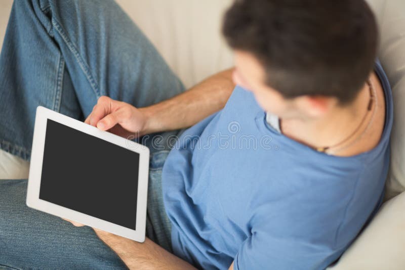 High Angle View of Casual Man Using Tablet Sitting on Couch Stock Photo ...