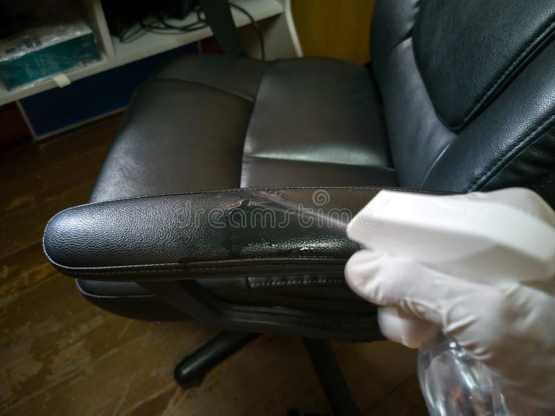 High Angle View, Cleaning a Black Work Chair, Using Alcohol Spray ...