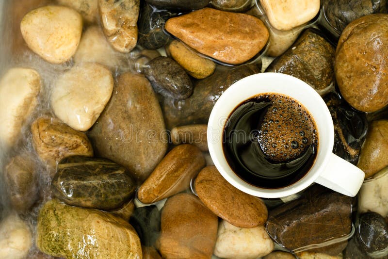 High Angle View of a Coffee on Rocks in a Stream Flowing with Clear ...