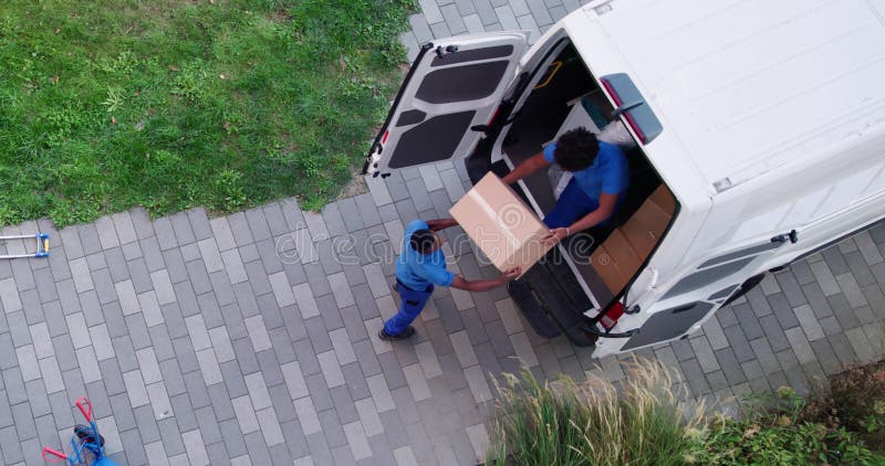 High Angle View of Delivery Men Unloading the Cardboard Boxes Stock ...