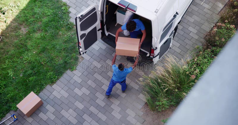High Angle View of Delivery Men Unloading the Cardboard Boxes Stock ...