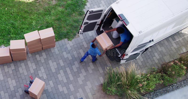 High Angle View of Delivery Men Unloading the Cardboard Boxes Stock ...