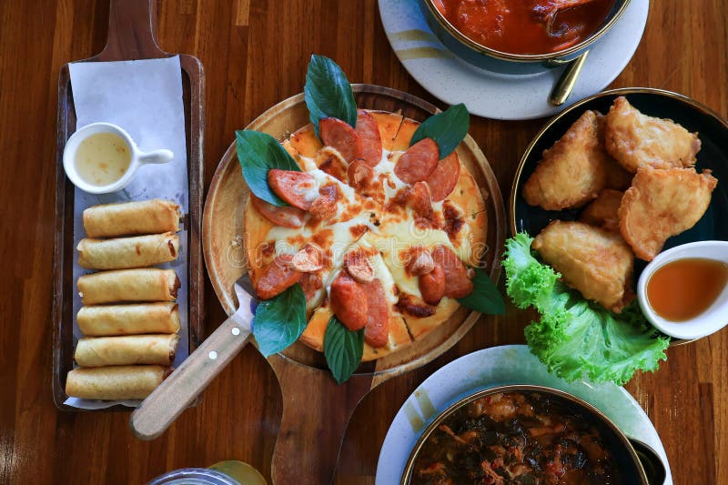 High Angle View. the Dining Table Consists of Pizza, Fried Spring Rolls ...