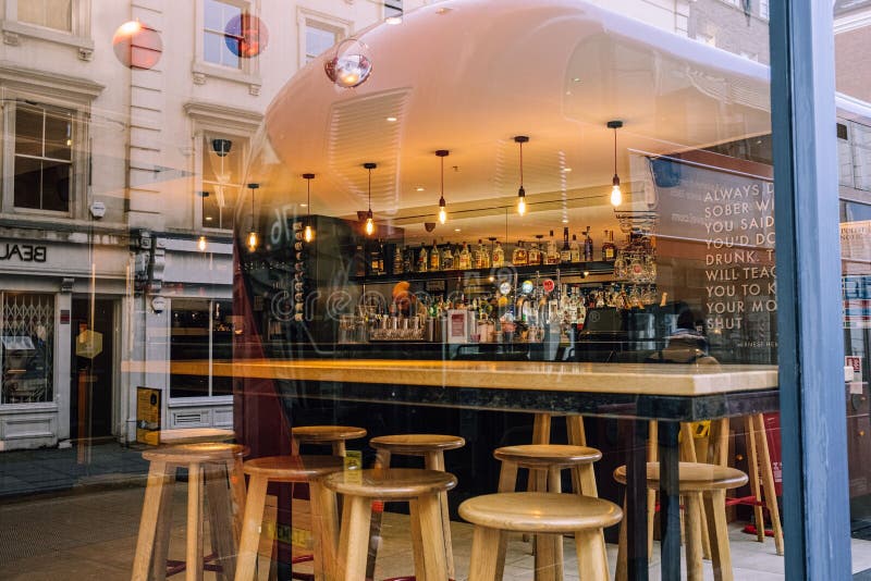 High-angle View of an Empty Restaurant Interior with Wooden Bar Stools ...