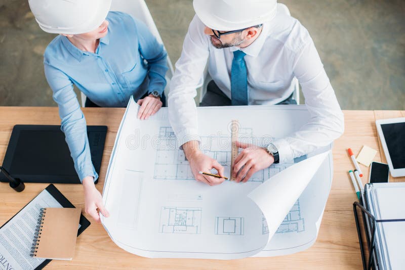 High Angle View of Experienced Architects Working with Building Plan ...